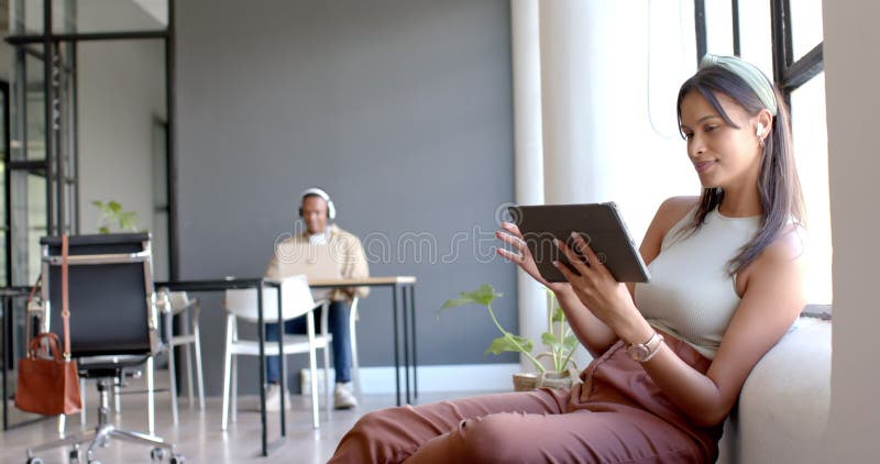 Using Tablet, Woman Working in Modern Office with Colleague in ...