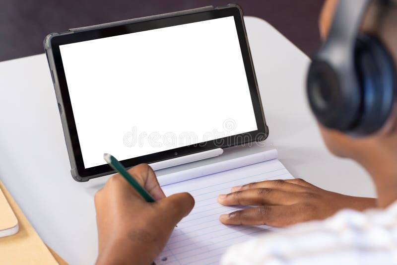 Using Tablet and Writing in Notebook, Student Studying in School ...