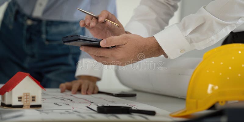 Using Technology in Construction. a Professional Using a Calculator To ...