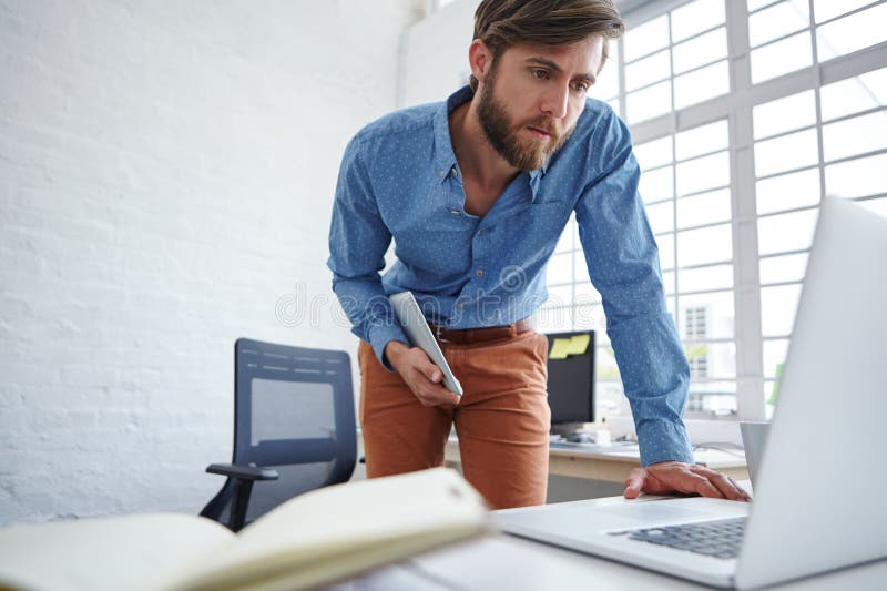 Using Technology To Stay Updated. a Handsome Designer Holding His ...