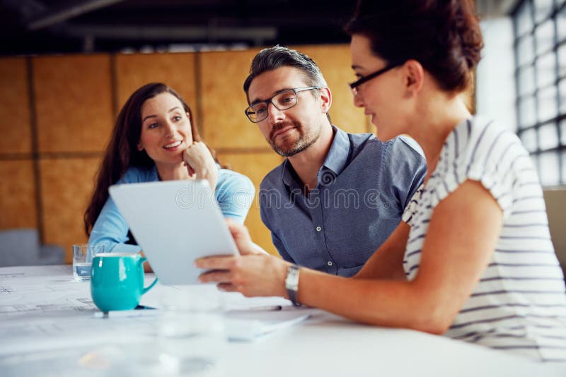 Using Technology To Visualize Their Ideas. a Group of Designers Using a ...