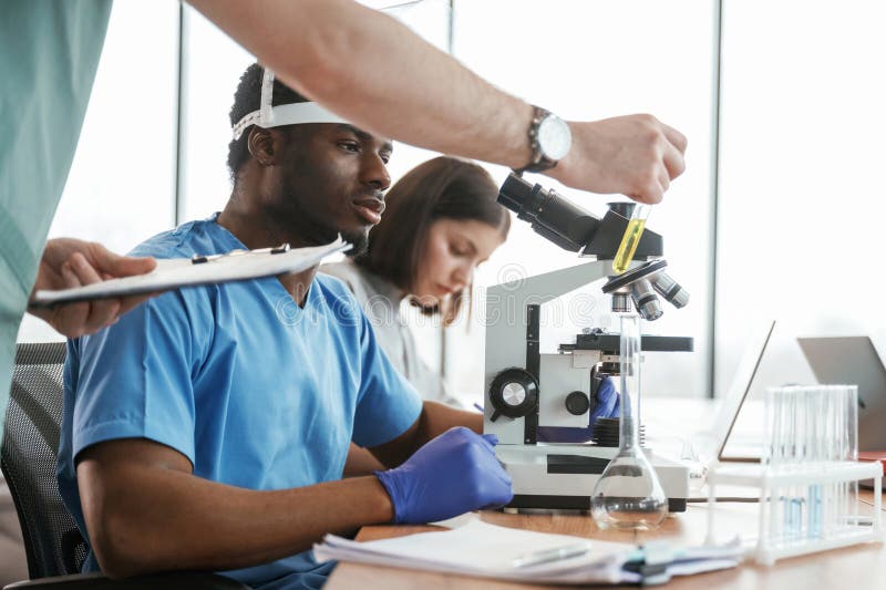 Using Test Tubes. Group of Doctors are Together Indoors Stock ...