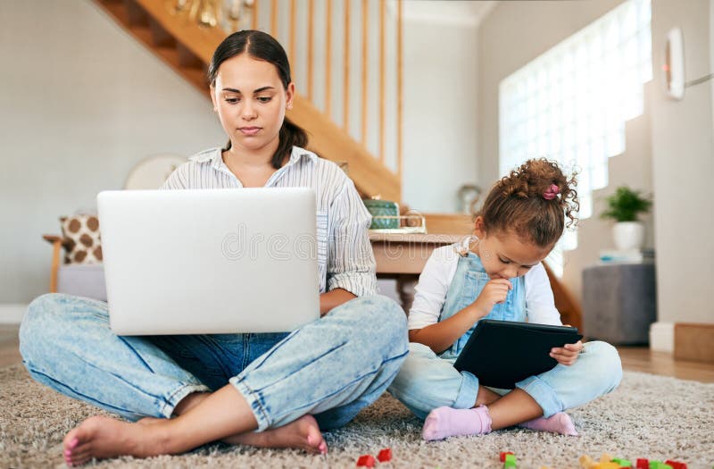 Using Their Devices To Get Work and Fun Done. a Mother and Her Little ...