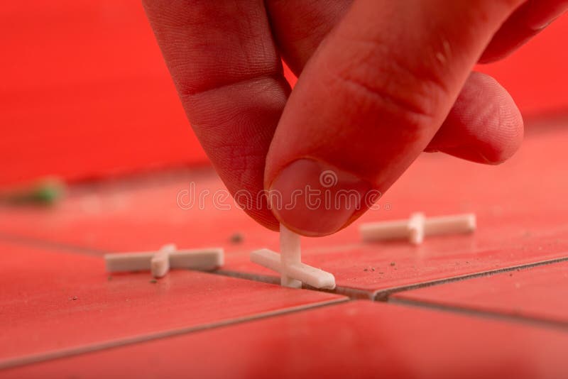 Using Tile Spacers on Red Tiles Stock Photo - Image of grouting ...