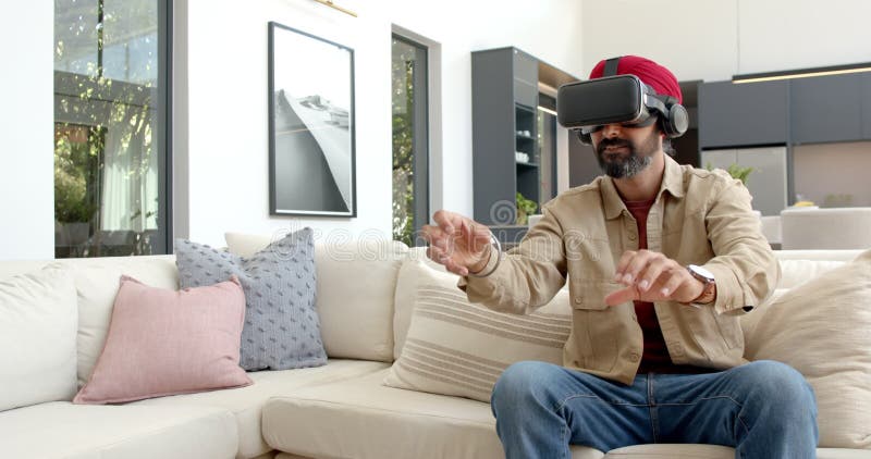 Using VR Headset, Man Sitting on Couch and Experiencing Virtual Reality ...