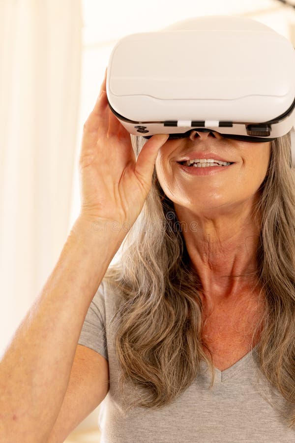Using VR Headset, Mature Woman Exploring Virtual Reality at Home Stock ...