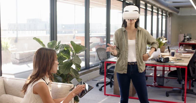 Using VR Headset, Woman Exploring Interior Design while Colleague ...