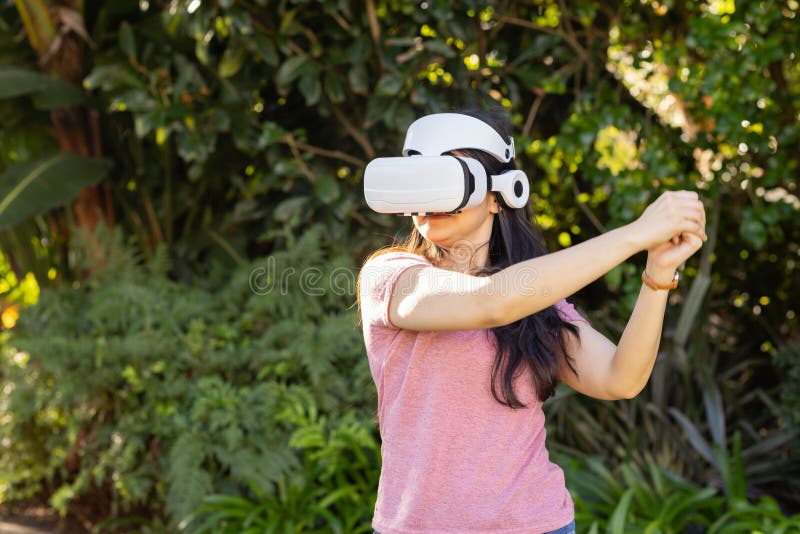 Using VR Headset, Woman Playing Virtual Reality Game Outdoors in Garden ...