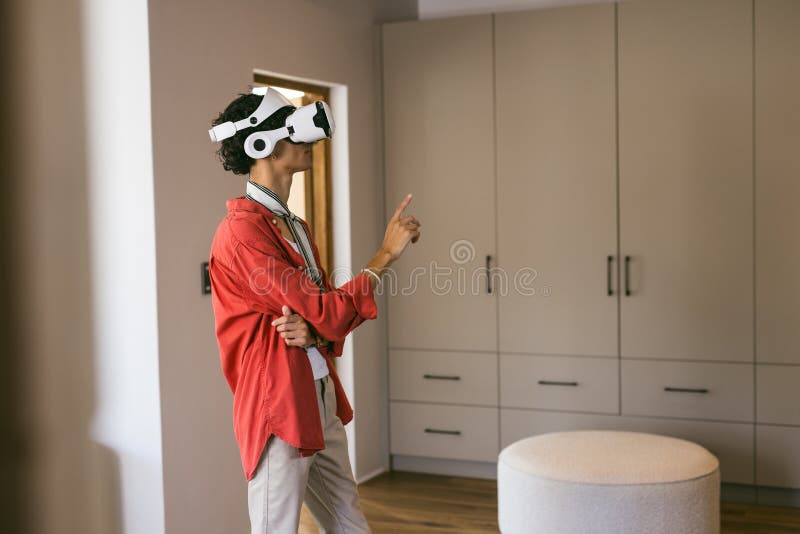 Using VR Headset, Young Man Exploring Virtual Environment in Modern ...