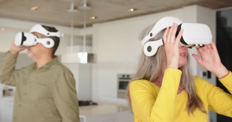 Using VR Headsets, Multiracial Senior Couple Exploring Virtual Reality ...