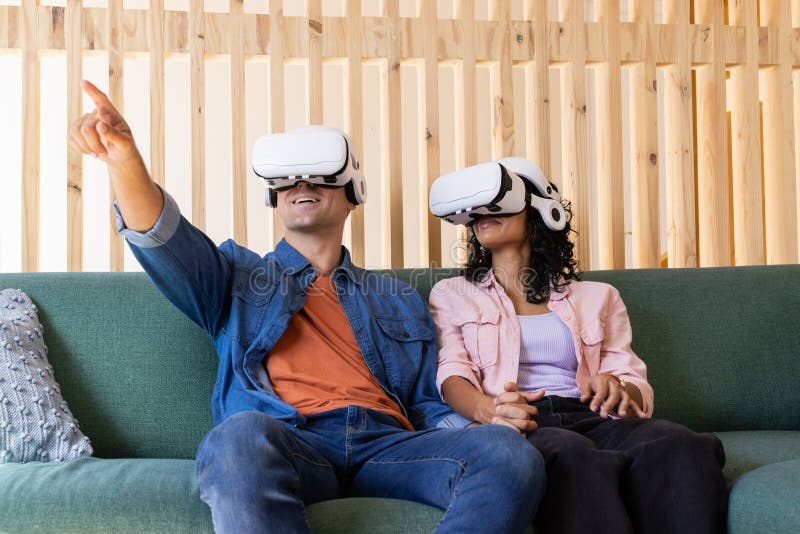 Using VR Headsets, Young Couple Experiencing Virtual Reality on Couch ...