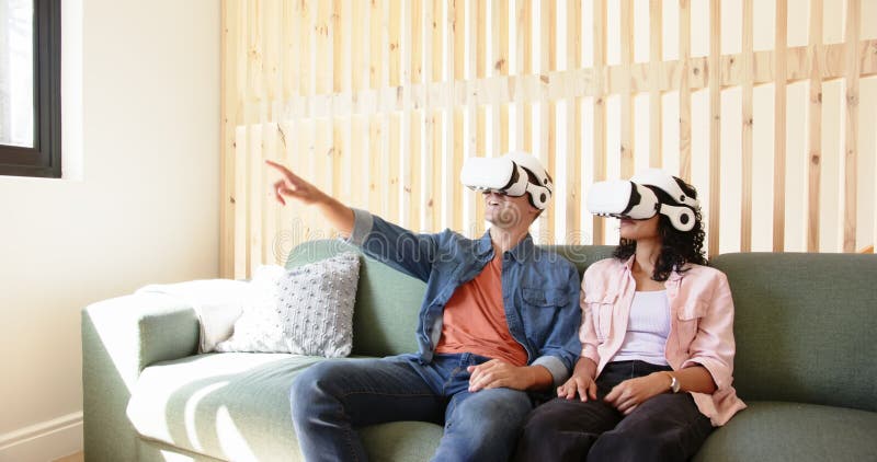 Using VR Headsets, Young Multiracial Couple Sitting on Couch and ...