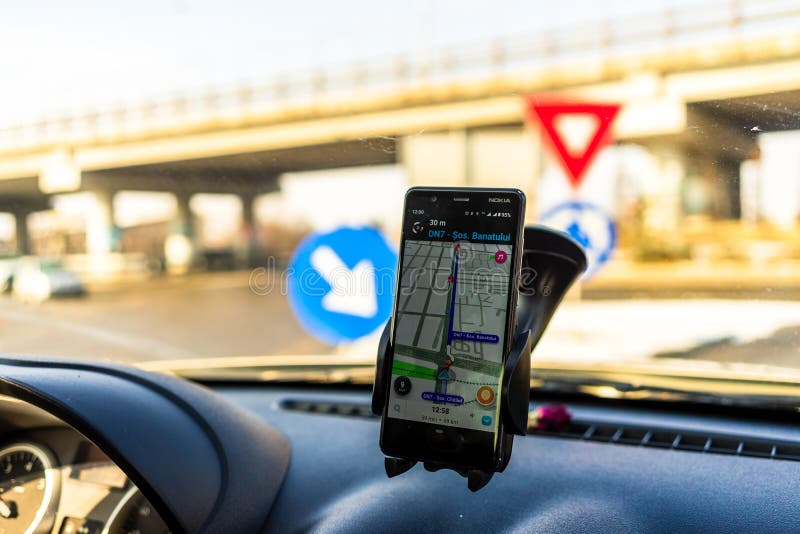 Using Waze Maps Application on Smartphone in Car Dashboard. Driver ...