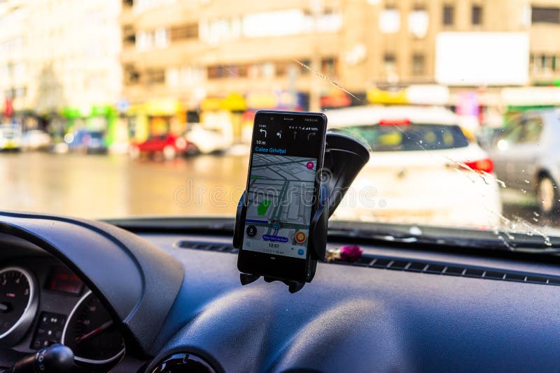 Using Waze Maps Application on Smartphone in Car Dashboard. Driver ...