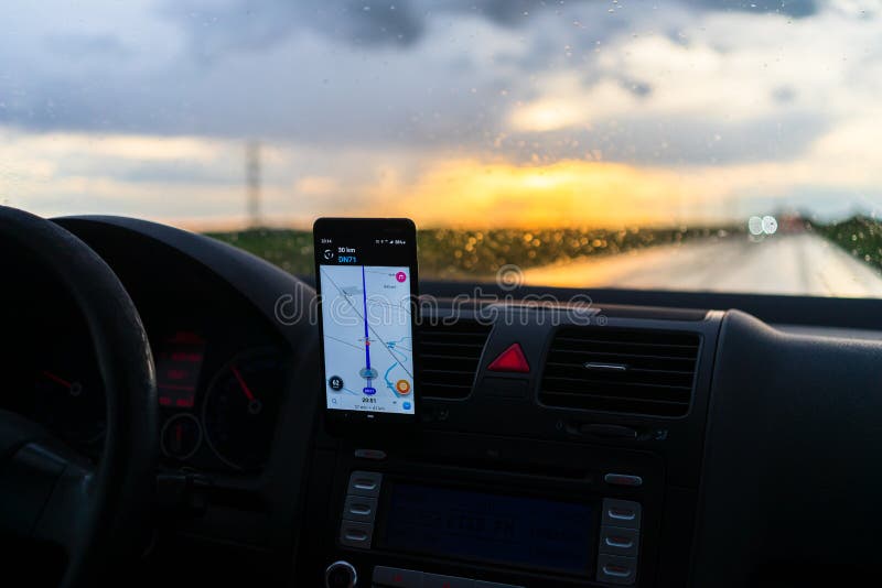 Using Waze Maps Application on Smartphone on Car Dashboard, Driver ...