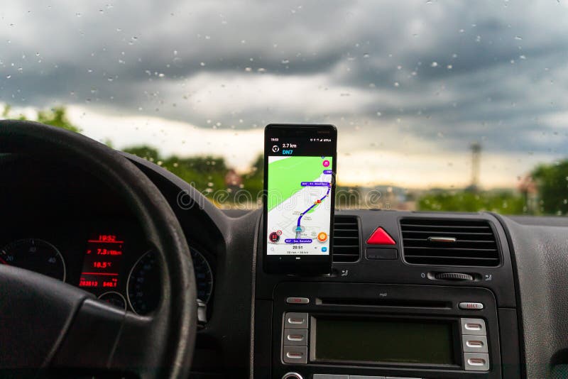 Using Waze Maps Application on Smartphone on Car Dashboard, Driver ...