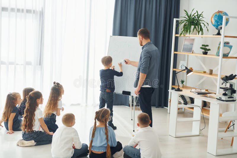 Using Whiteboard. Group of Children Students in Class at School with ...