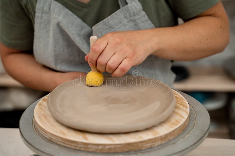 Using Wooden Handle Sponge To Smooth the Surface of a Clay Product in a ...