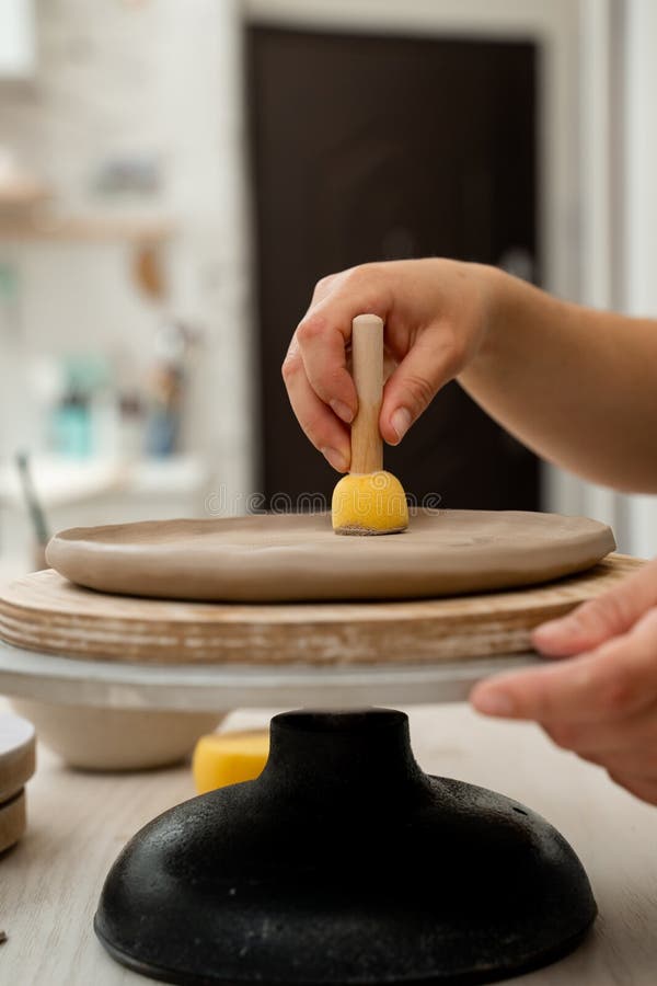 Using Wooden Handle Sponge To Smooth the Surface of a Clay Product in a ...