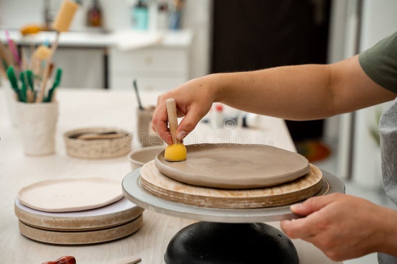 Using Wooden Handle Sponge To Smooth the Surface of a Clay Product in a ...