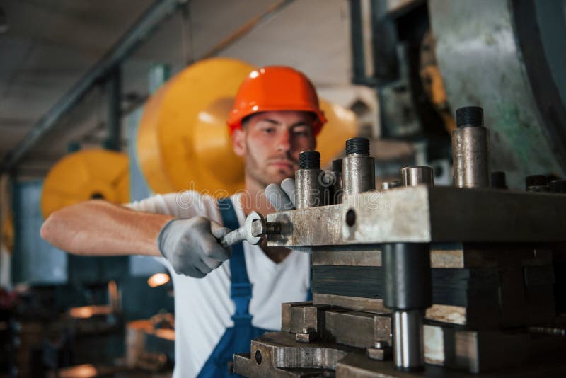 Metallurgical Factory. Man in Uniform Works on the Production Stock ...