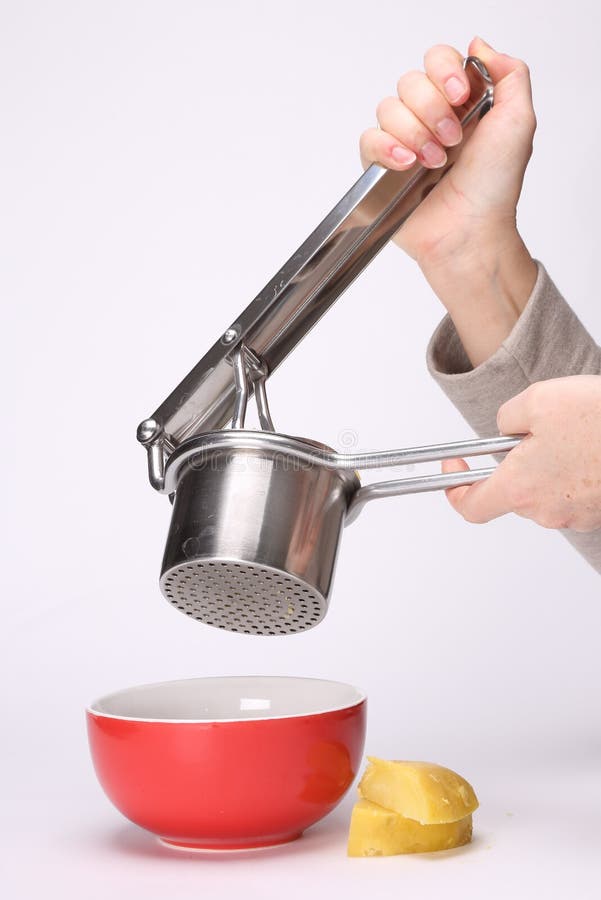 Usintg a Potato-Ricer stock photo. Image of potatoes - 29613208