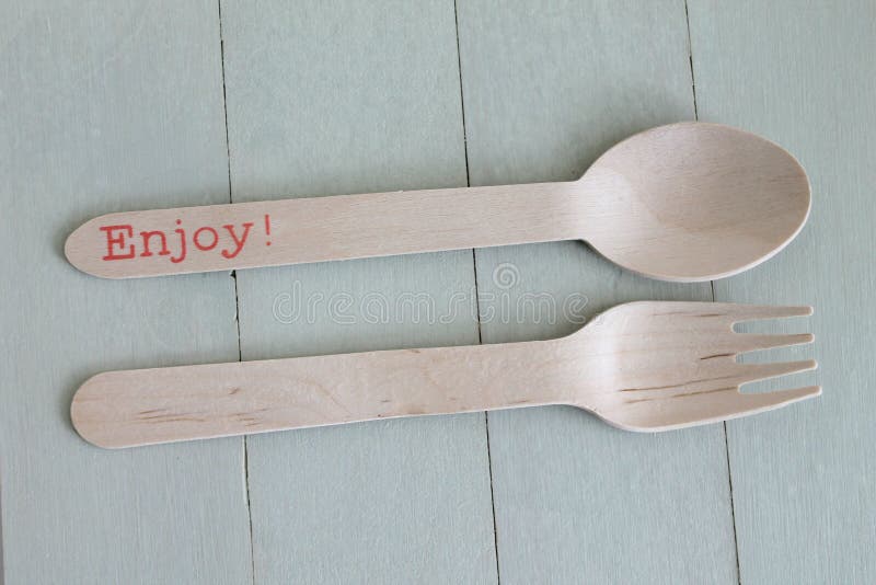 Decorative Wooden Eating Utensils on a Pastel Wooden Background Stock ...