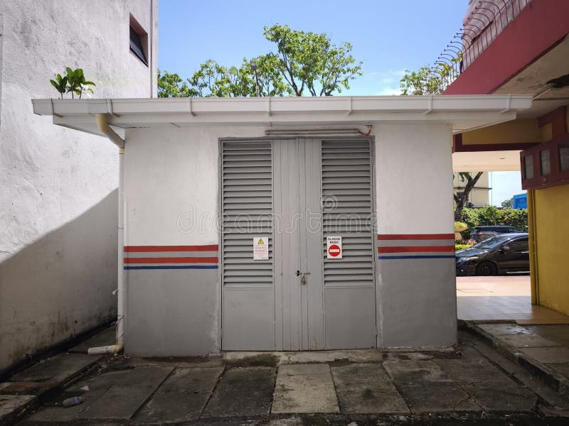Utility Building with Warning Signs and Striped Design Under Clear Sky ...
