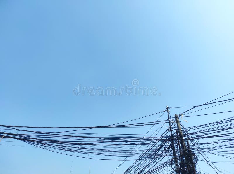 Utility Cables Stretched Across a Clear Blue Sky from a Telephone Pole ...