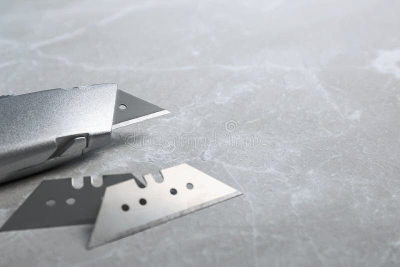 Utility Knife and Blades on Light Grey Table, Closeup. Space for Text ...