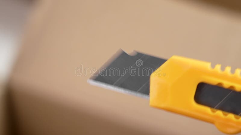 Utility Knife or Box Cutter in Hand with Retractable Segmented Blade ...