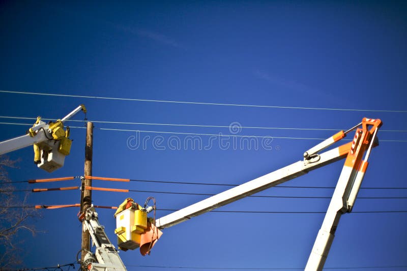 Electric Company Performing Utility Work Up on Power Lines Stock Photo ...