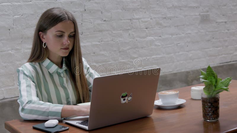 Utilizing Her Computer at a Cafe, a Young Ukrainian Woman Earns a ...