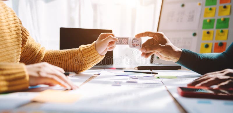 Ux Developer And Ui Designer Brainstorming About Mobile App Interface Wireframe Design With