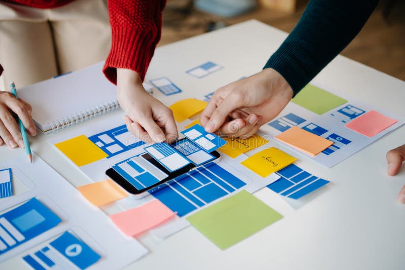 Ux Developer And Ui Designer Brainstorming About Mobile App Interface Wireframe Design With