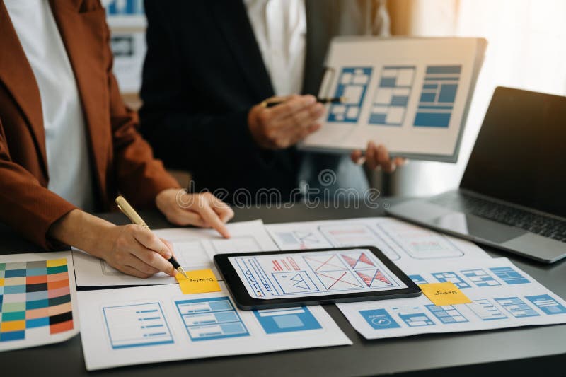 Ux Developer And Ui Designer Brainstorming About Mobile App Interface Wireframe Design With
