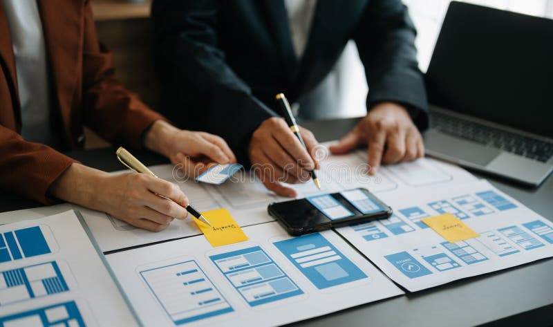 Ux Developer And Ui Designer Brainstorming About Mobile App Interface Wireframe Design With