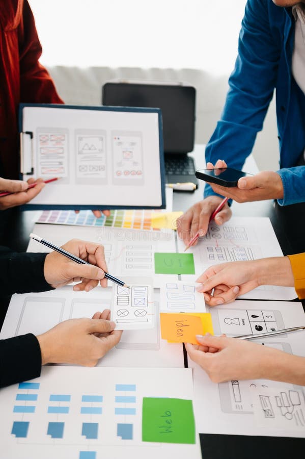 Ux Developer And Ui Designer Brainstorming About Mobile App Interface Wireframe Design With