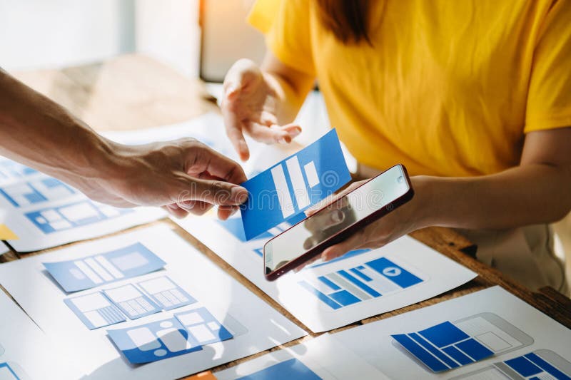 Ux Developer And Ui Designer Brainstorming About Mobile App Interface Wireframe Design With