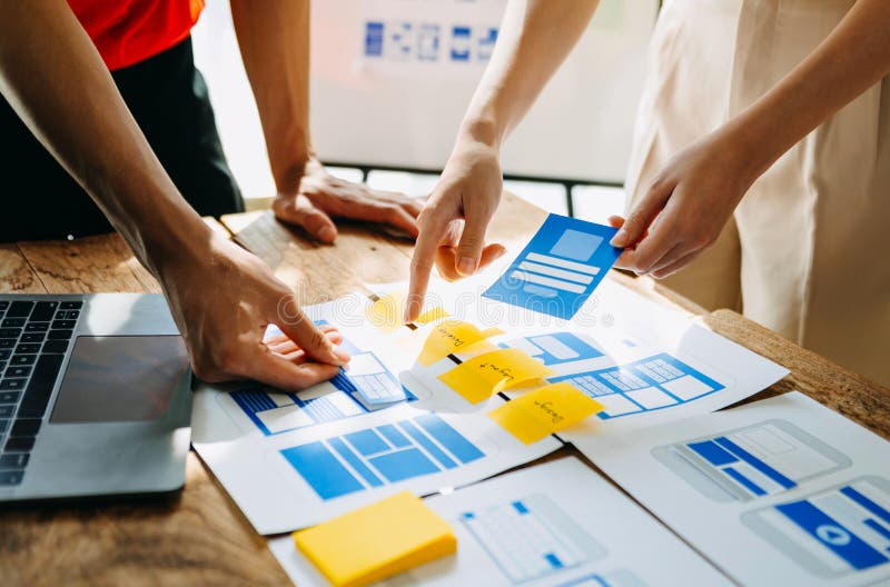 Ux Developer And Ui Designer Brainstorming About Mobile App Interface Wireframe Design With