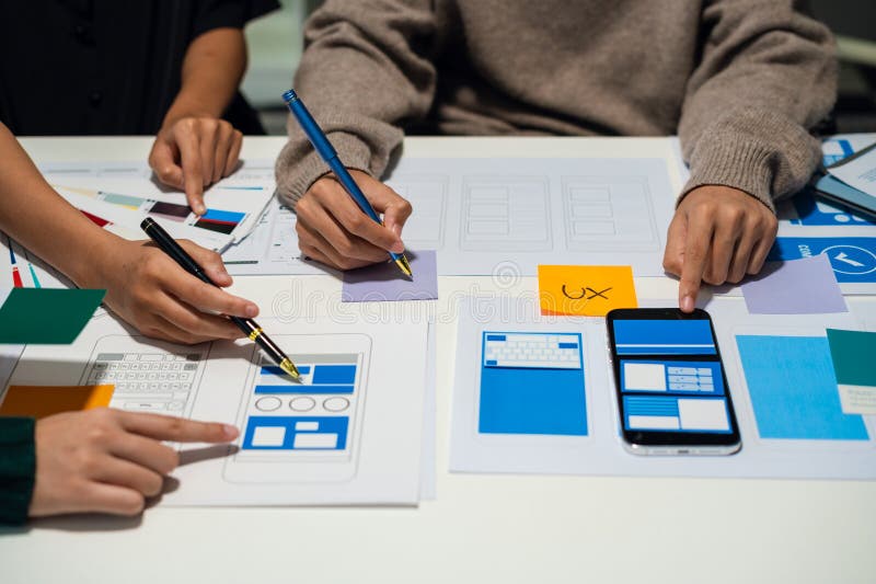 Ux Developer And Ui Designer Brainstorming About Mobile App Interface Wireframe Design With