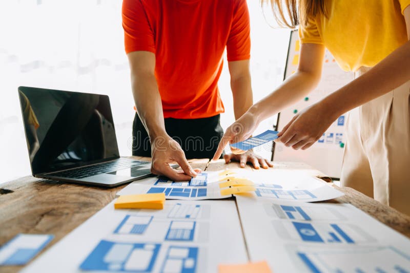 Ux Developer And Ui Designer Brainstorming About Mobile App Interface Wireframe Design With