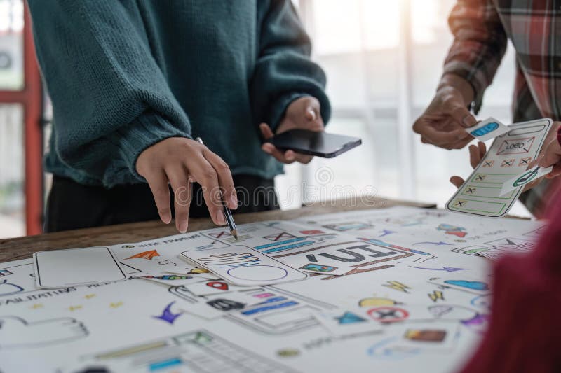 Ux Developer And Ui Designer Brainstorming About Mobile App Interface Wireframe Design At Modern