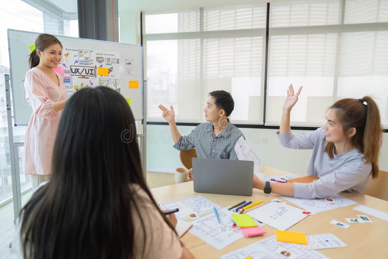 Ux Developer And Ui Designer Presenting And Testing Mobile App Interface Design On Whiteboard In