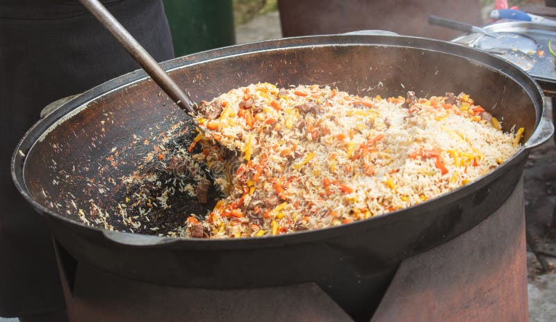Uzbek Pilaf Cooked in a Cauldron Over a Fire Stock Photo - Image of ...