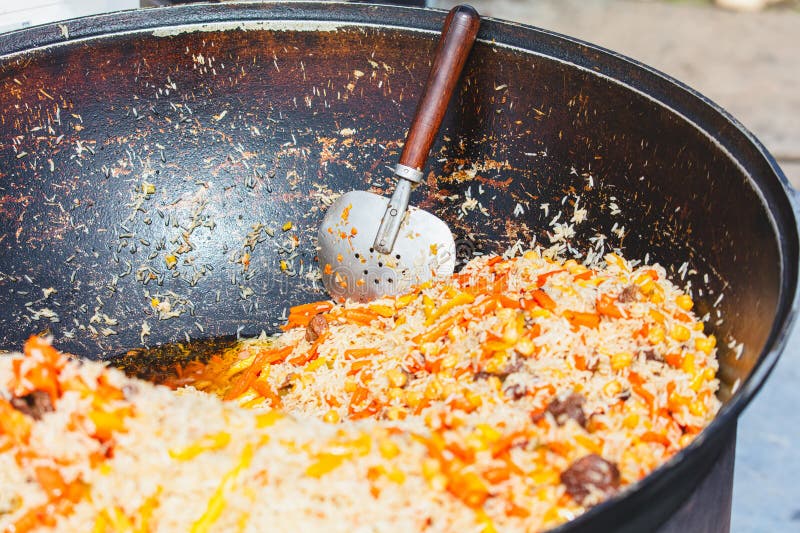 Uzbek Pilaf Cooked in a Cauldron Over a Fire Stock Photo - Image of ...