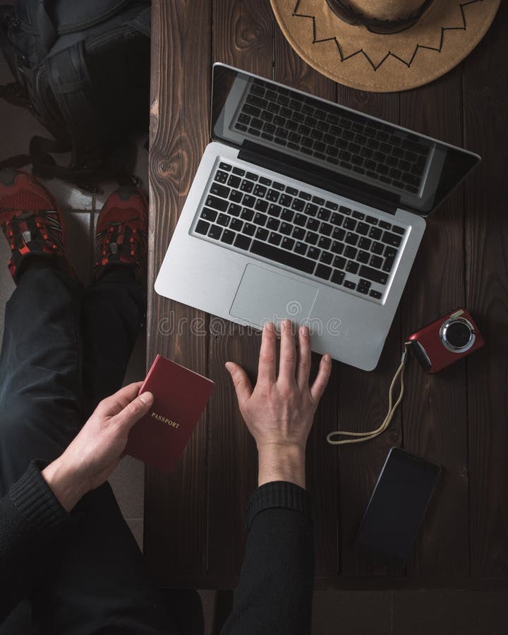 Vacation Planning on the Computer. the Man is Holding a Passport Stock ...