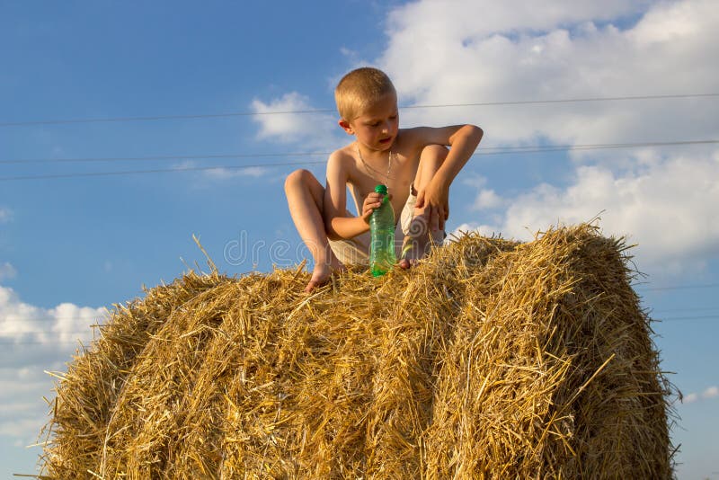 Boy Sitting on Hay in the Field,vacations on Wheat Field with Hay Bale ...