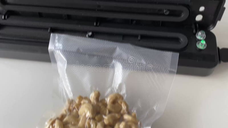 Vacuum Packaging Machine and Vacuum Bagged Nuts. Device for Packing ...