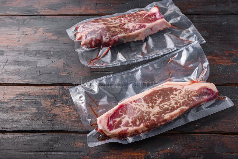 Vacuum Packed Meat , Top Blade Beef Steak on Dark Old Wooden Table ...